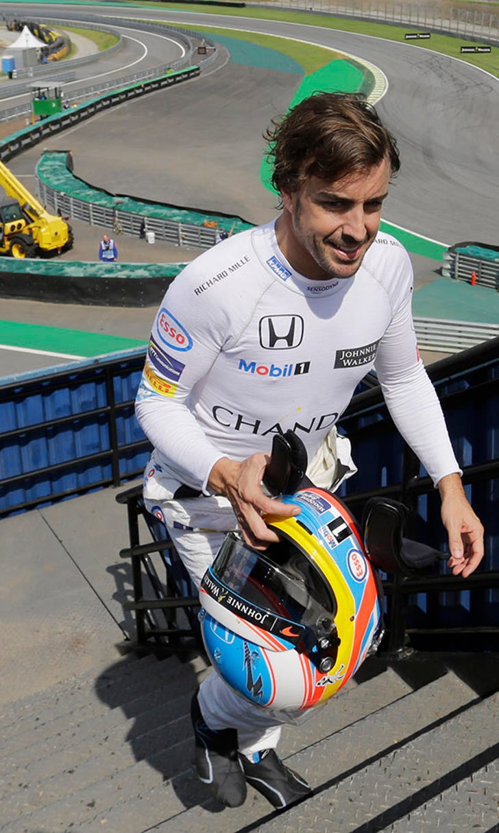 Fernando Alonso operates a camera during F1 practice | FOX Sports